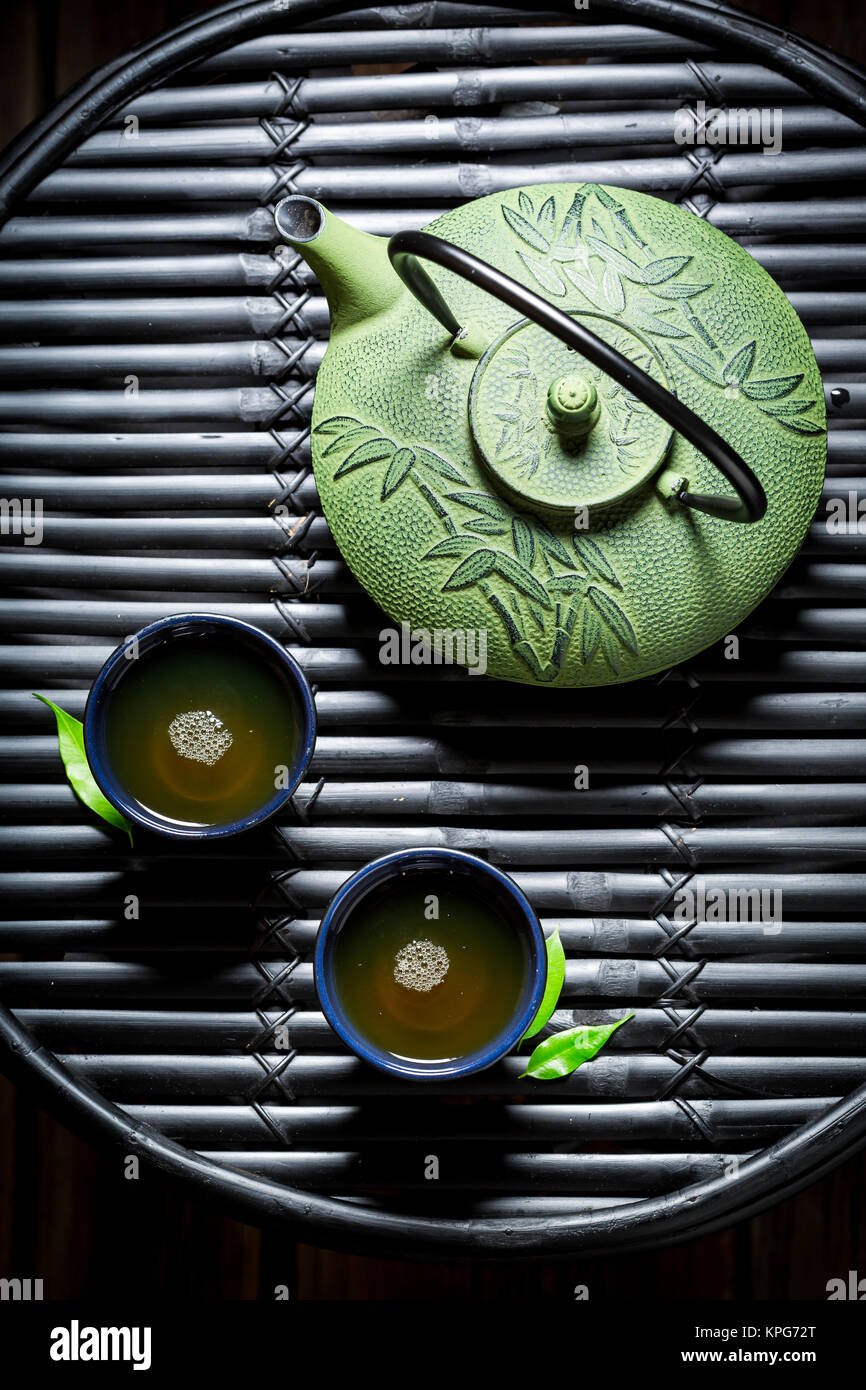 Aromatic green tea on black bamboo table Stock Photo - Alamy