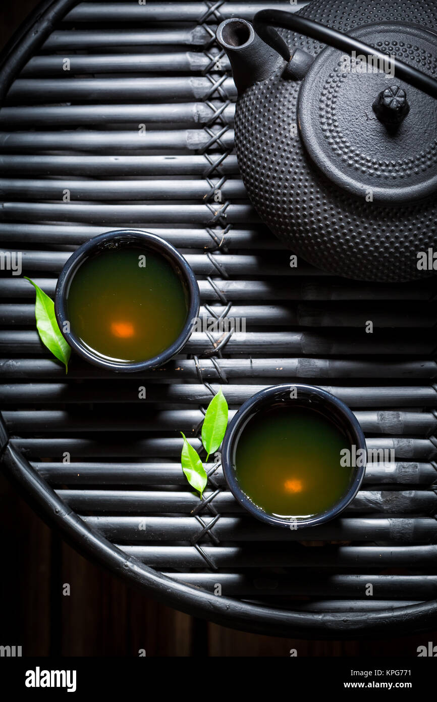 Top view of green tea with teapot on black table Stock Photo - Alamy
