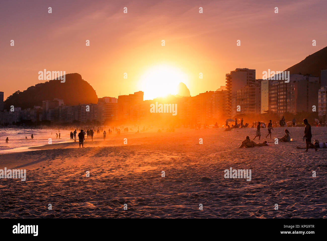 Stunning sunset over a group of people at Ipanema beach in Rio De ...