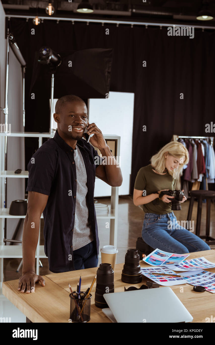 afican american photographer talking on smartphone Stock Photo - Alamy