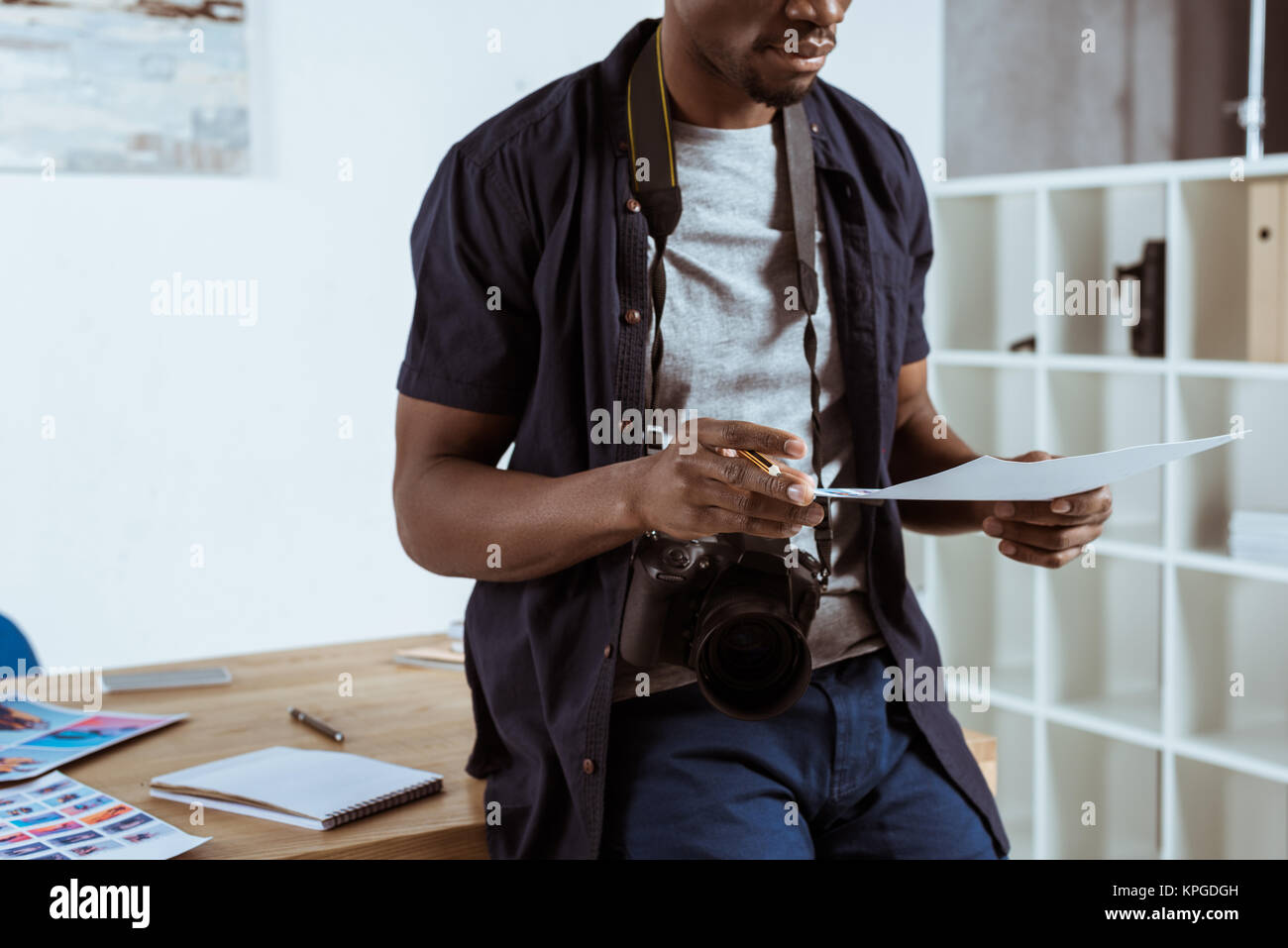 cropped shot of african american photographer with photoshoot examples ...