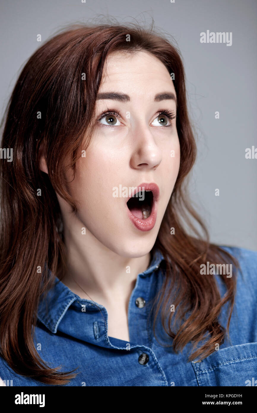 Portrait of young woman with shocked facial expression Stock Photo - Alamy