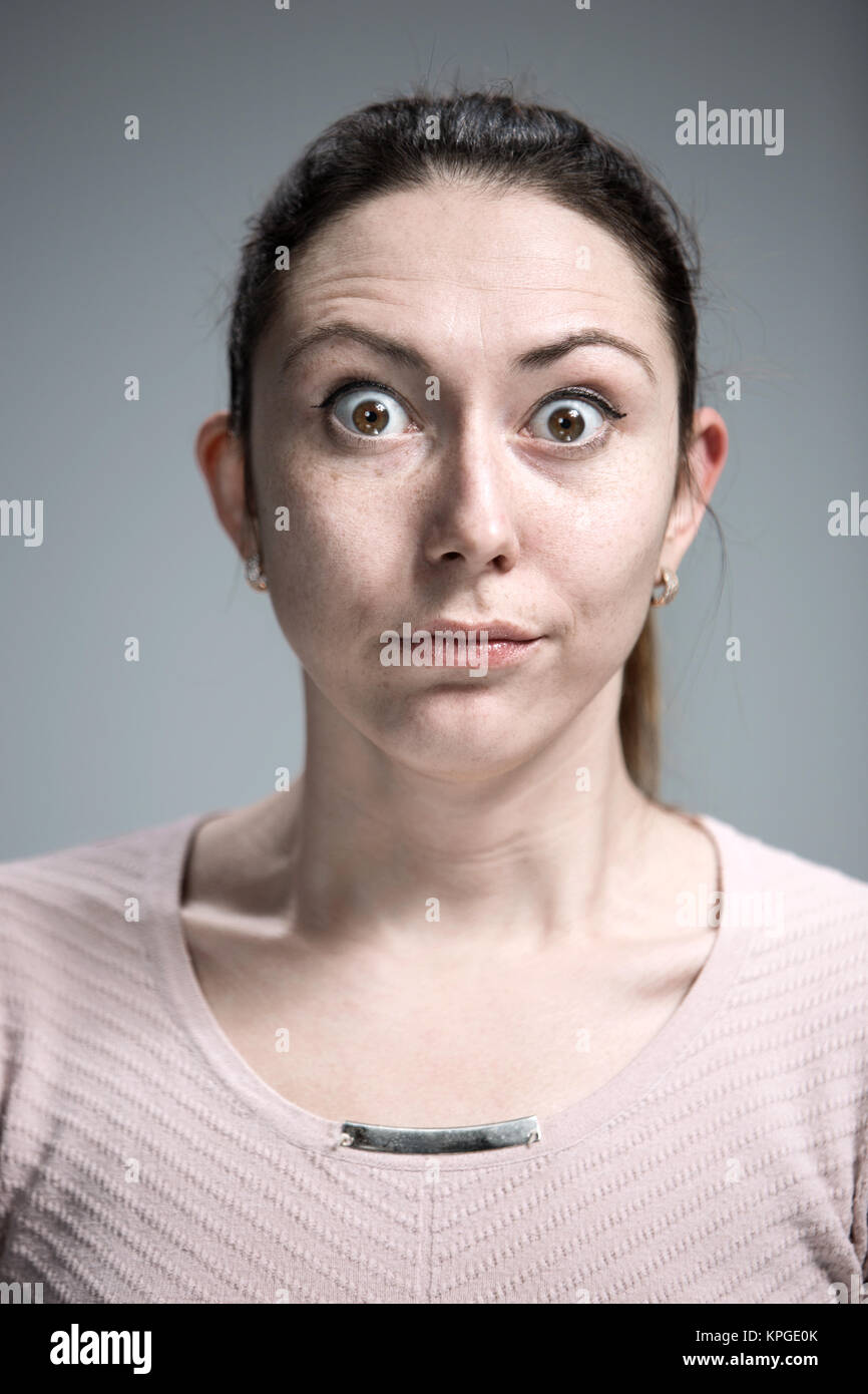 Portrait of young woman with shocked facial expression Stock Photo - Alamy
