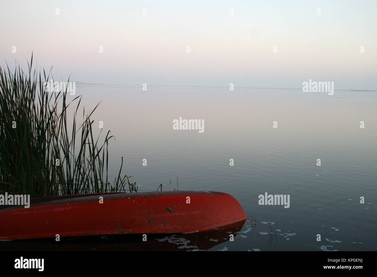 Small red rowing boat upside down on the lagoon, Hermanus, South Africa ...