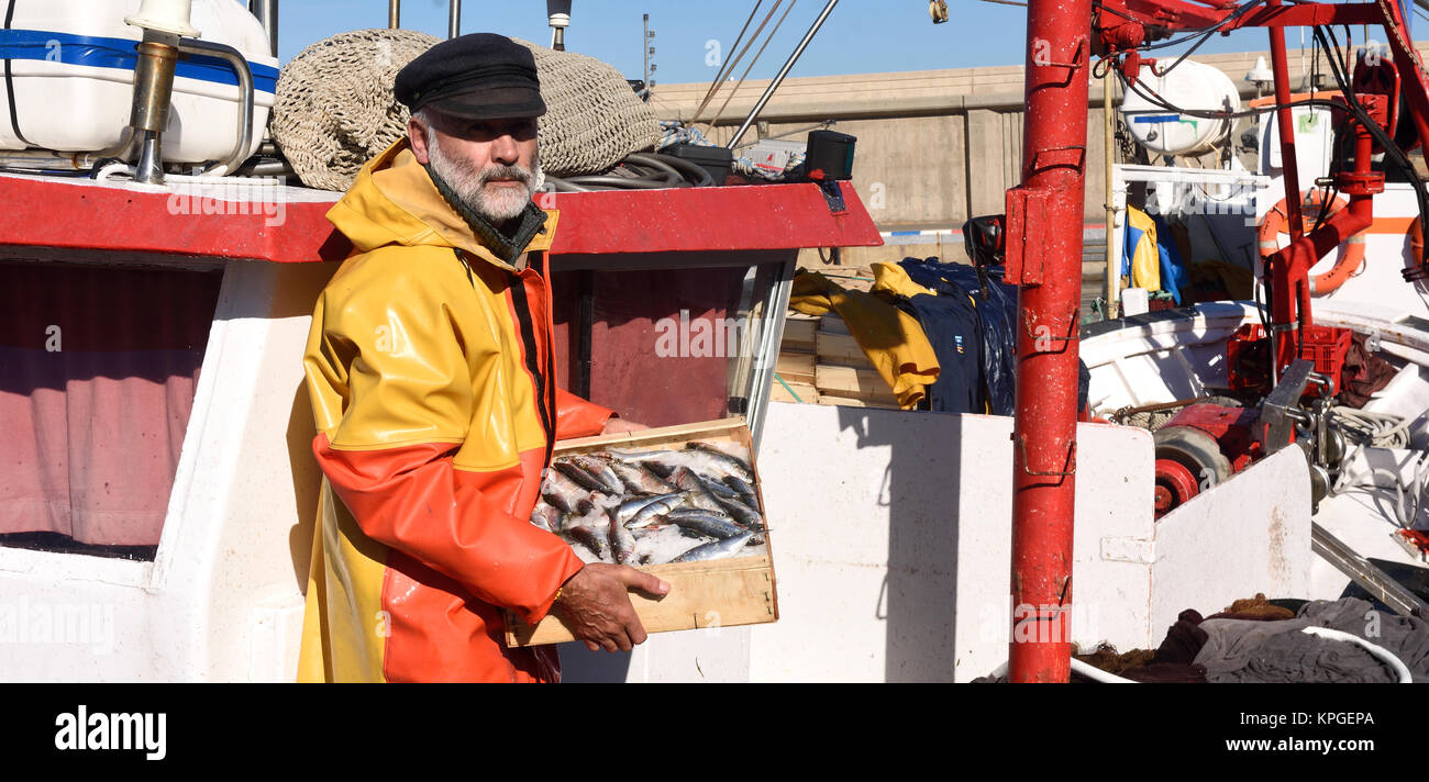 fisherman with a fish box inside a fishing boat Stock Photo - Alamy