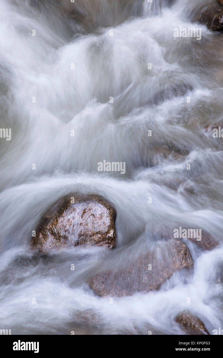 Water flowing around rocks in Roaring Fork Creek along the Roaring Fork ...