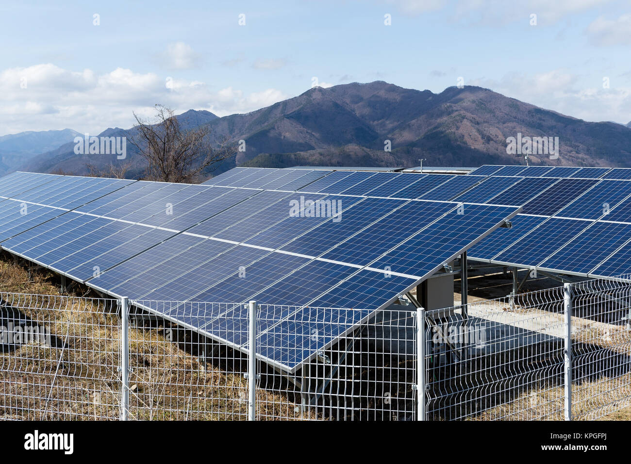 Solar power plant with mountain background Stock Photo - Alamy