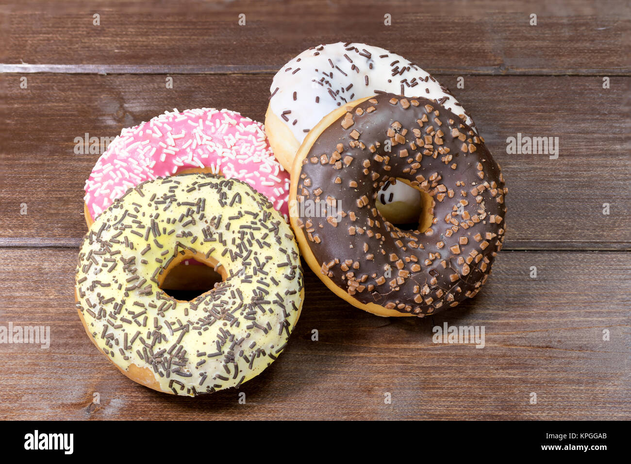 Four American donuts on a desk Stock Photo - Alamy