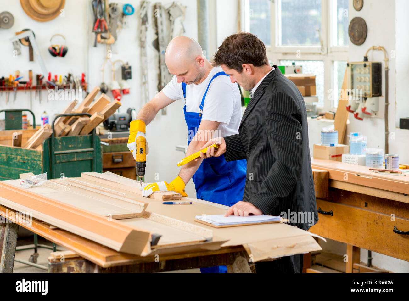 boss and worker together in a carpenter's workshop Stock Photo - Alamy