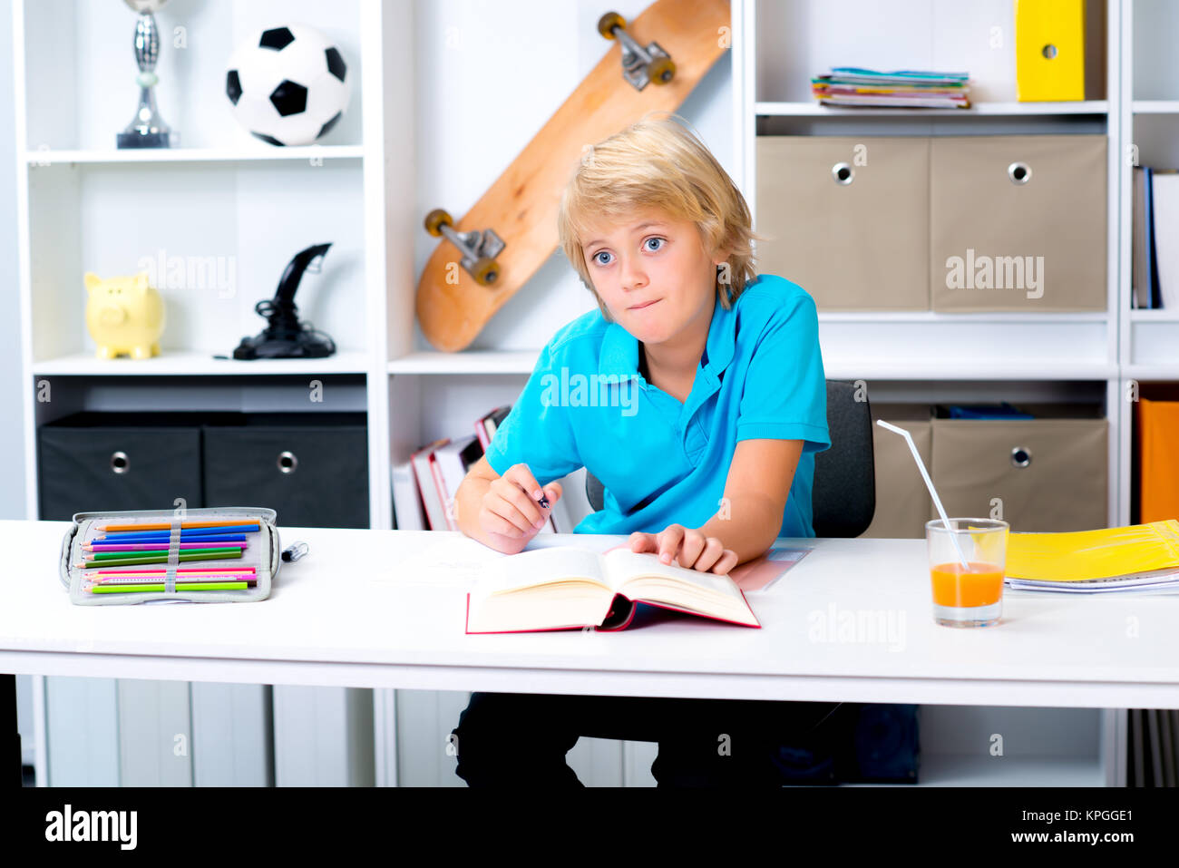 blond boy doing homework in his room Stock Photo - Alamy
