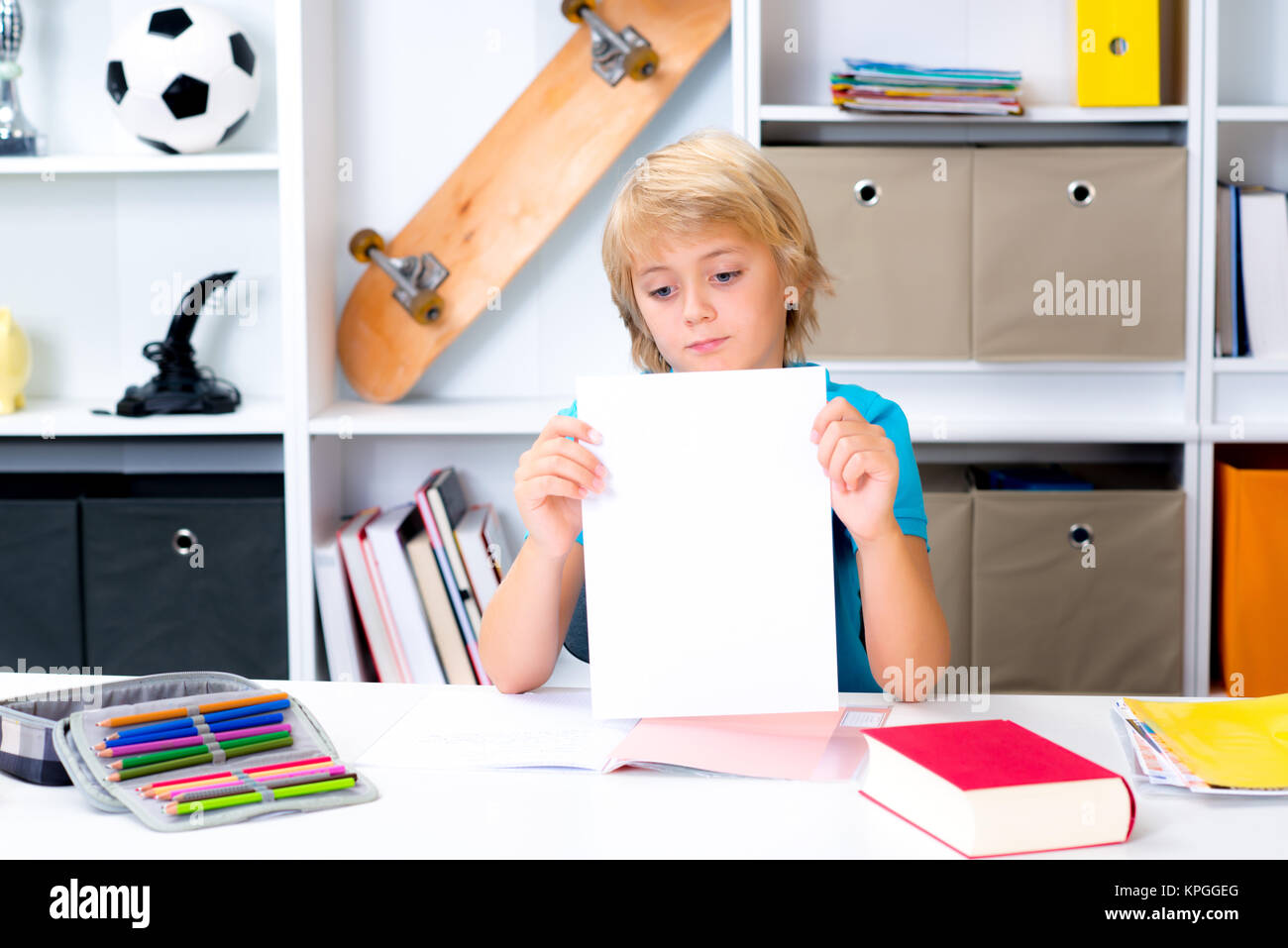 blond boy on desk with bad report card Stock Photo - Alamy