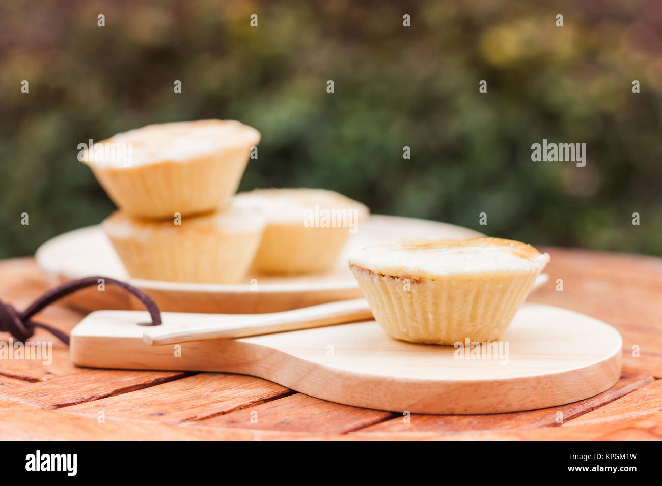 Mini pies on wooden plate Stock Photo - Alamy