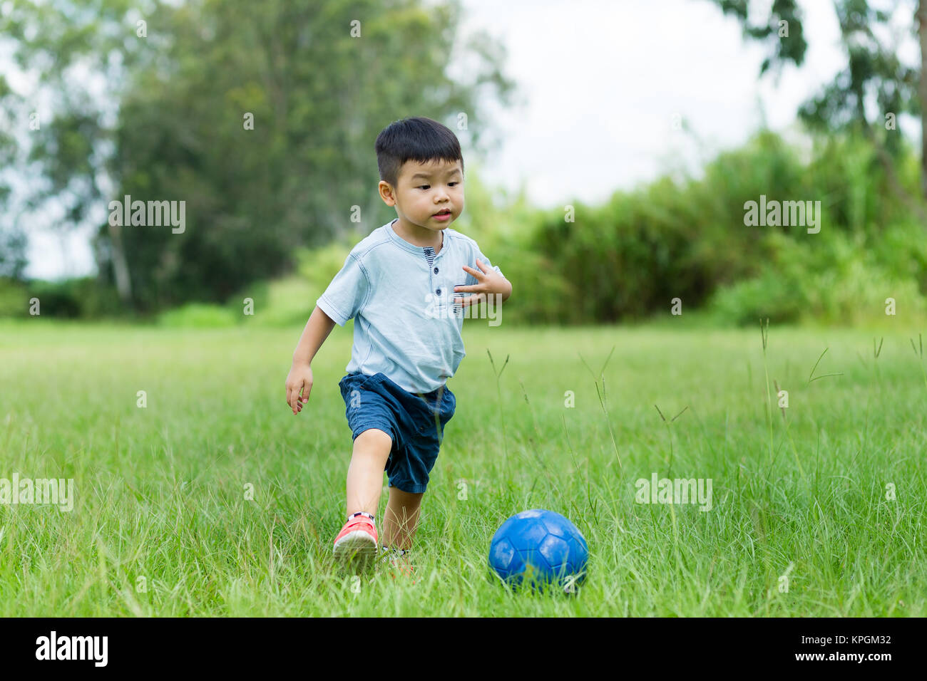 Little boy play soccer at outdoor Stock Photo - Alamy