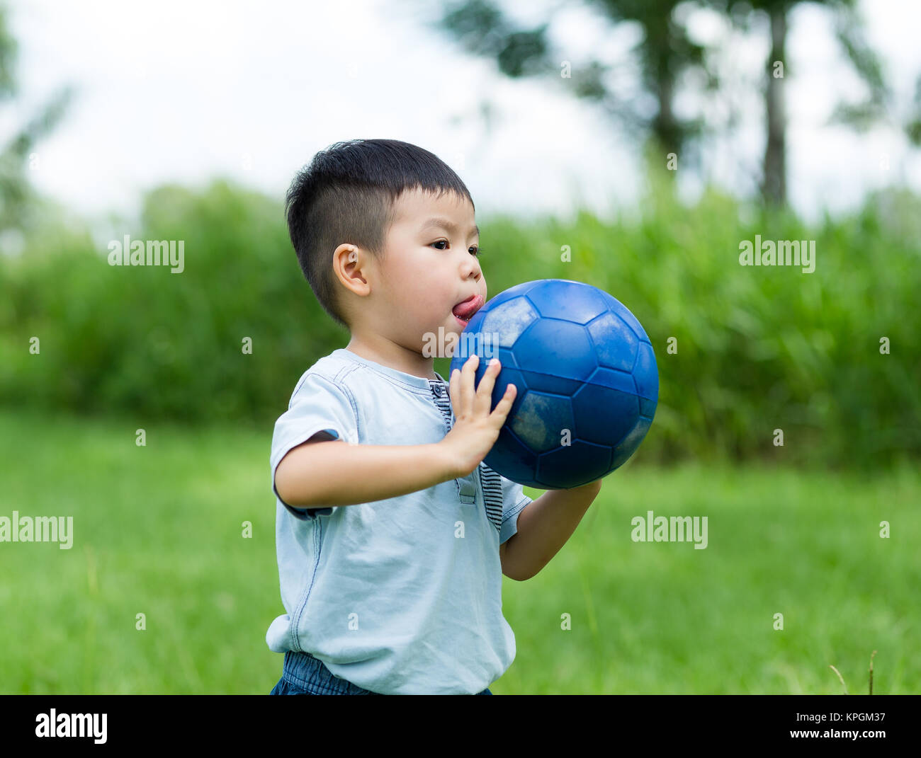Kid play soccer ball at outdoor Stock Photo - Alamy
