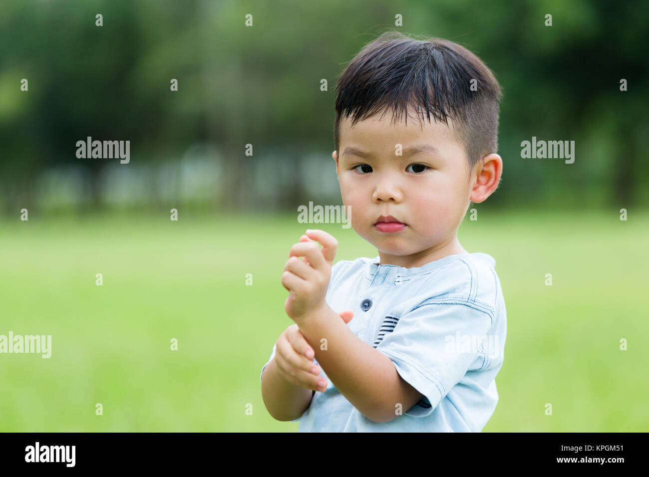 Asian boy feeling itchy on his hand Stock Photo - Alamy