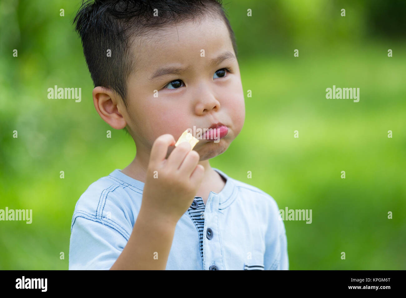 Little kid eating snack Stock Photo - Alamy