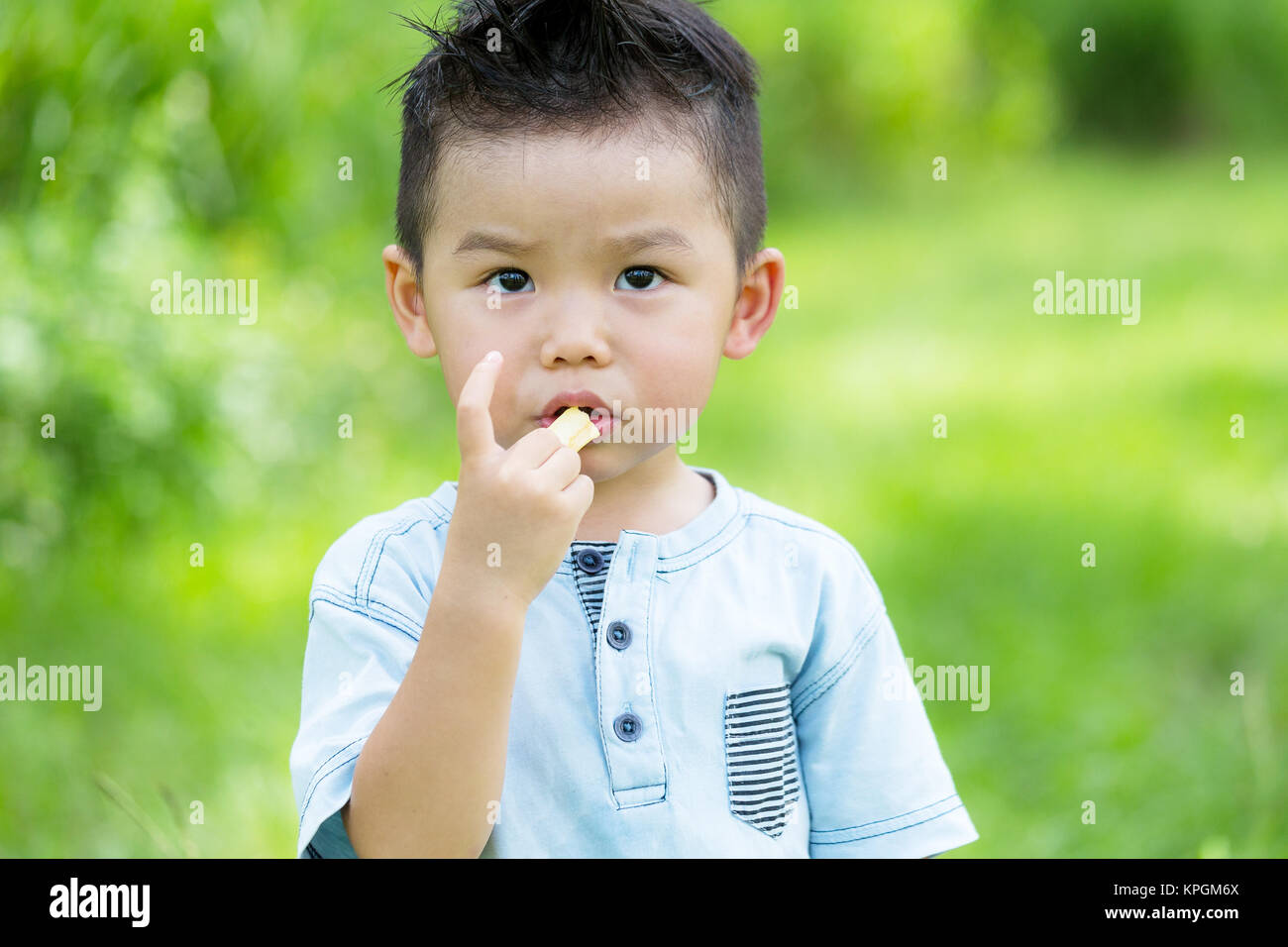 Little boy eating finger food Stock Photo - Alamy