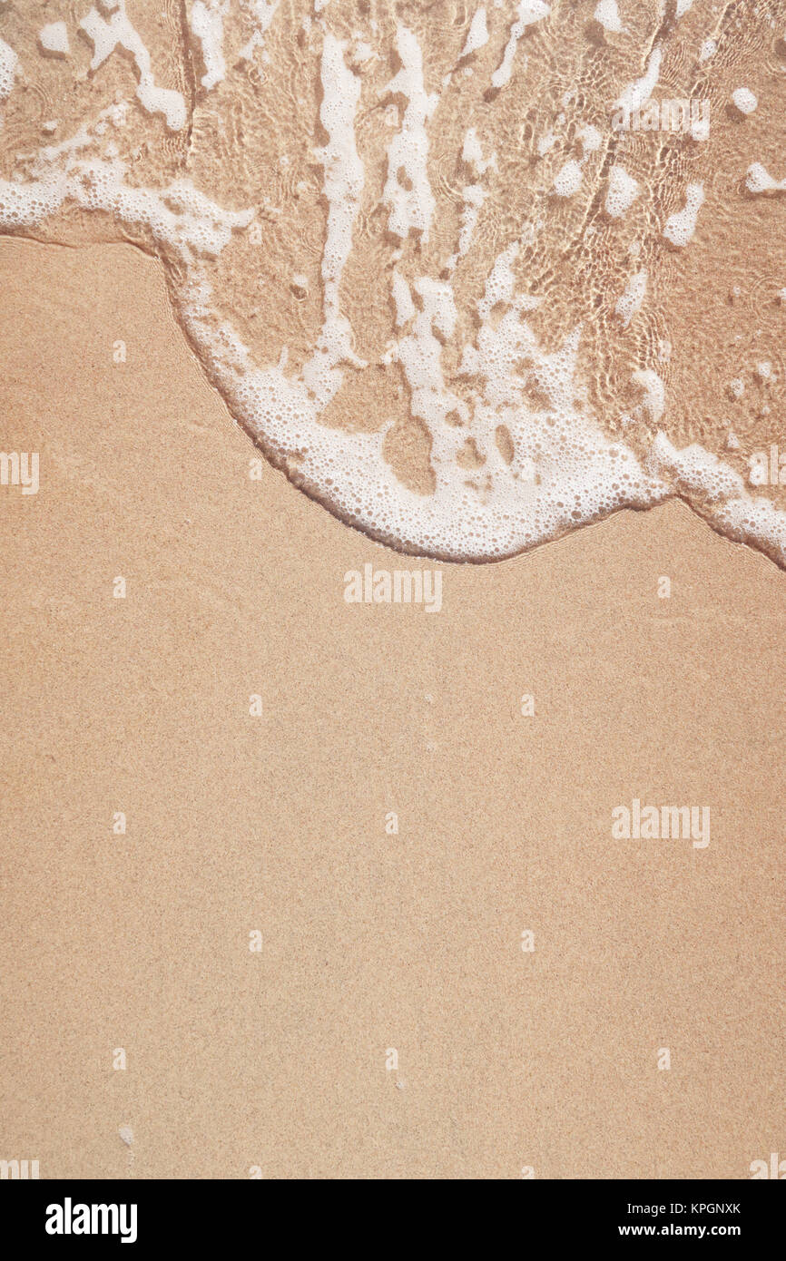 Transparent soft wave on sandy beach Stock Photo - Alamy