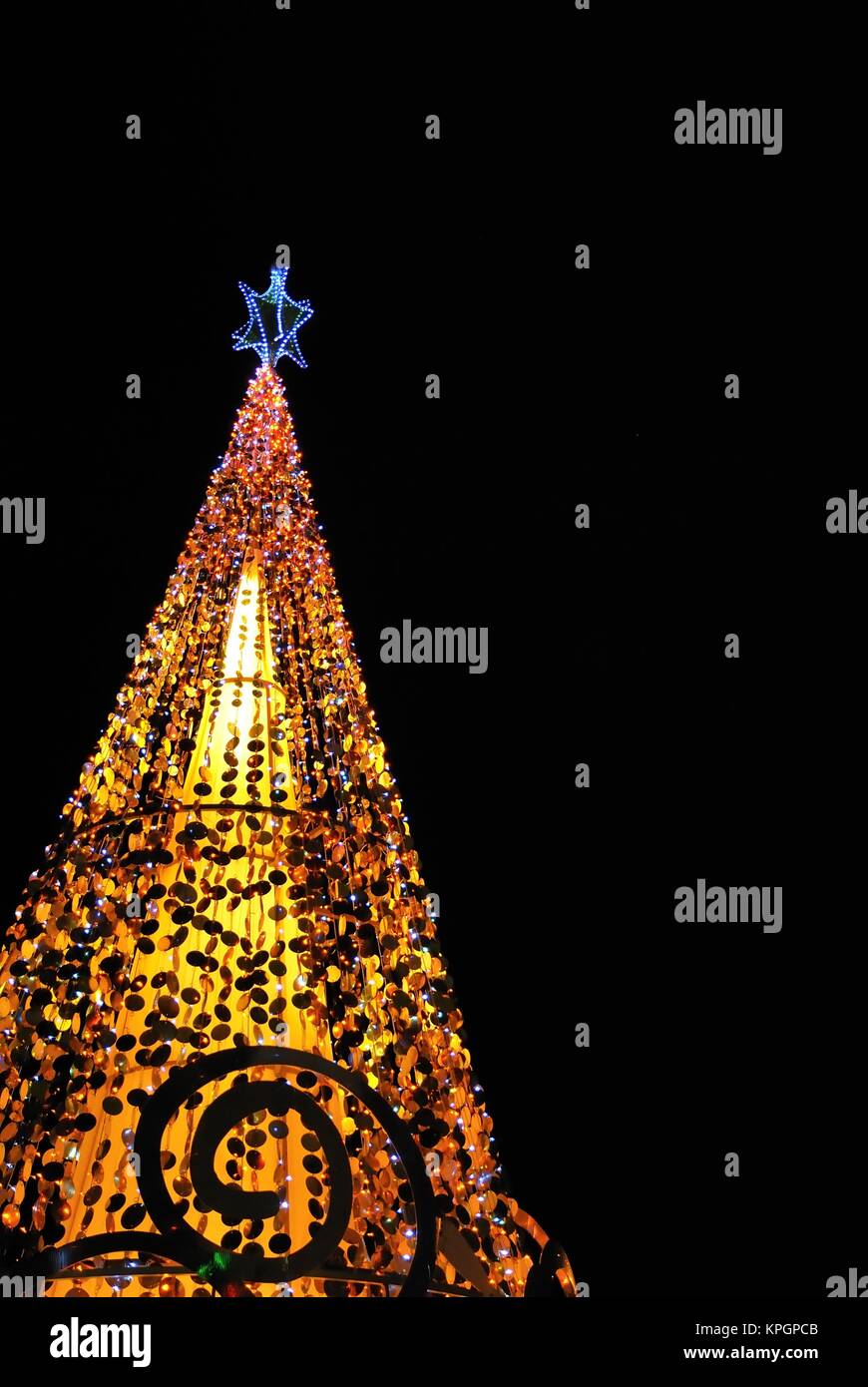 Christmas tree lit up with decorations and colorful lights. Suitable ...