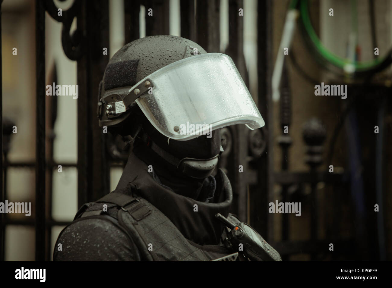 Riot police officer waiting in the rain Stock Photo - Alamy