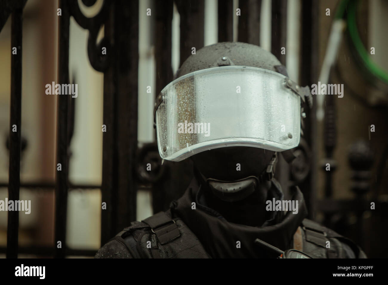 Riot police officer waiting in the rain Stock Photo - Alamy