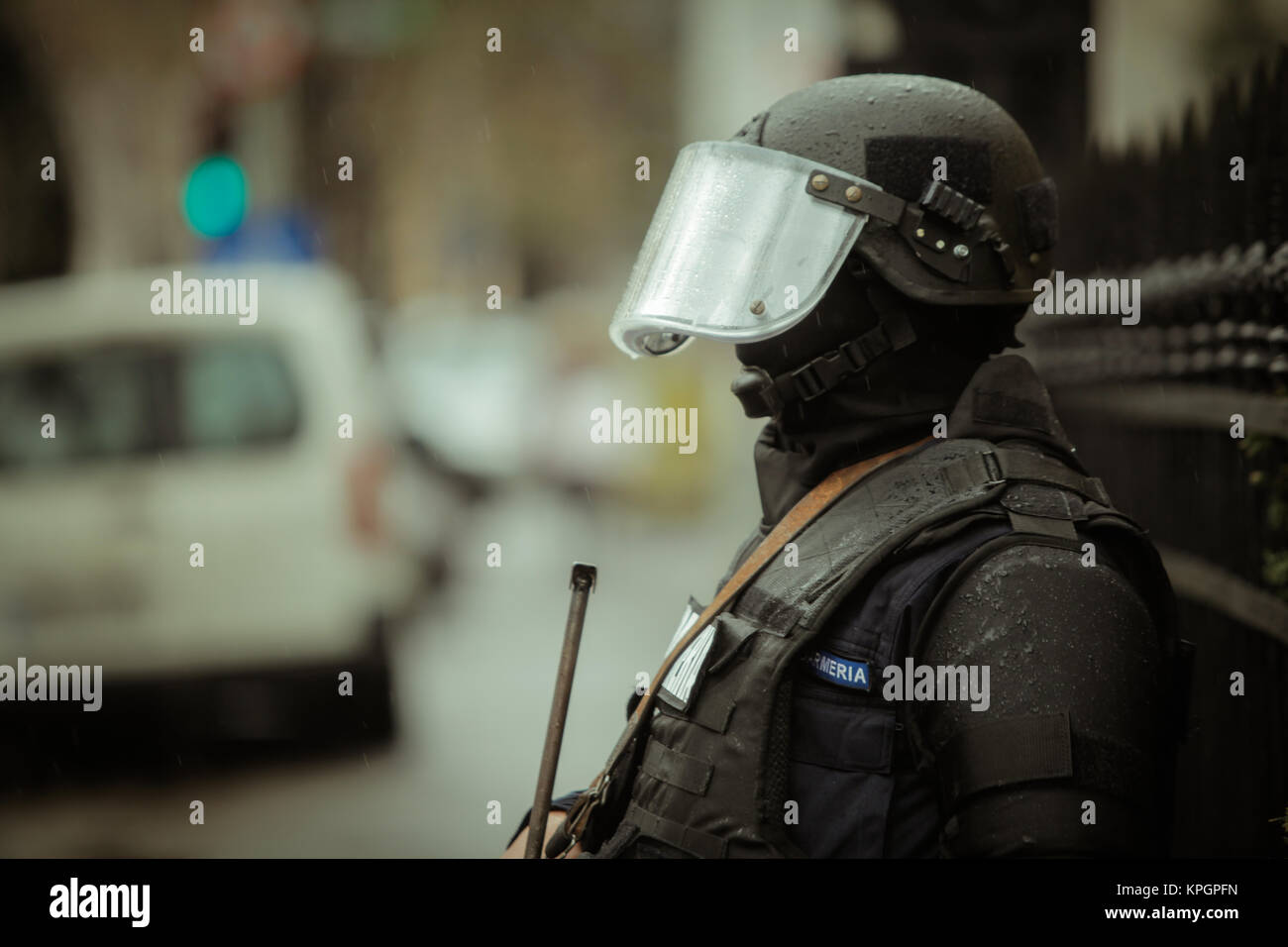 Riot police officer waiting in the rain Stock Photo - Alamy