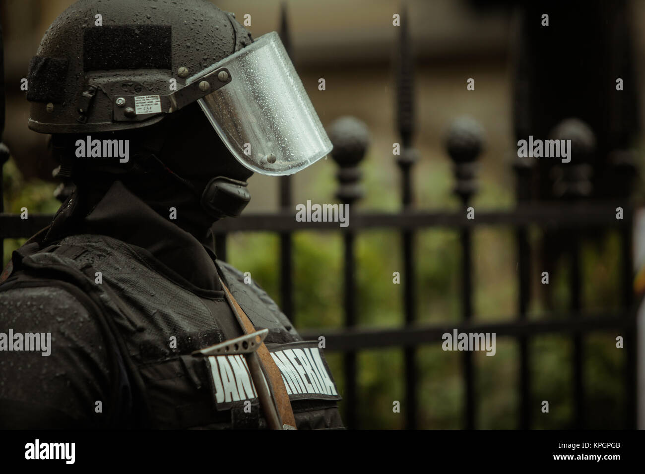 Riot police officer waiting in the rain Stock Photo - Alamy