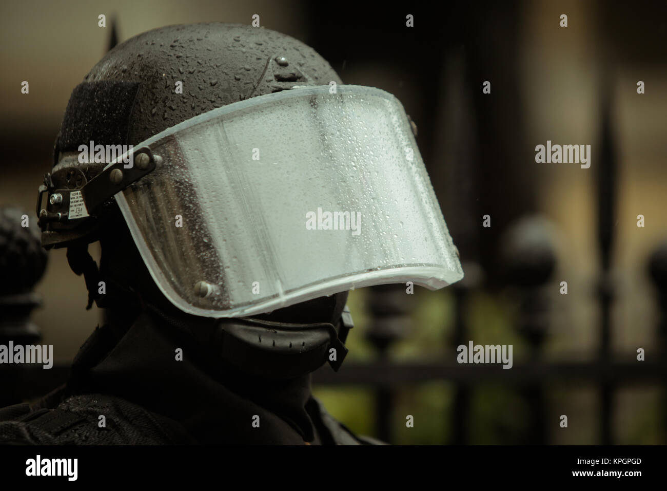 Riot police officer waiting in the rain Stock Photo - Alamy