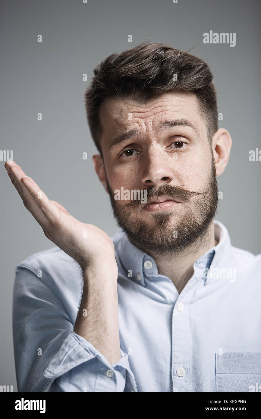 Man is looking bored. Over gray background Stock Photo - Alamy