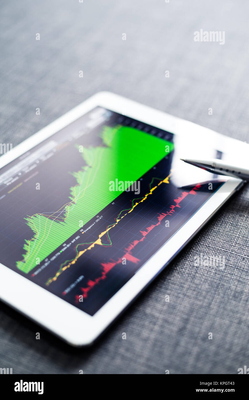 Tablet computer with stock market graph Stock Photo - Alamy