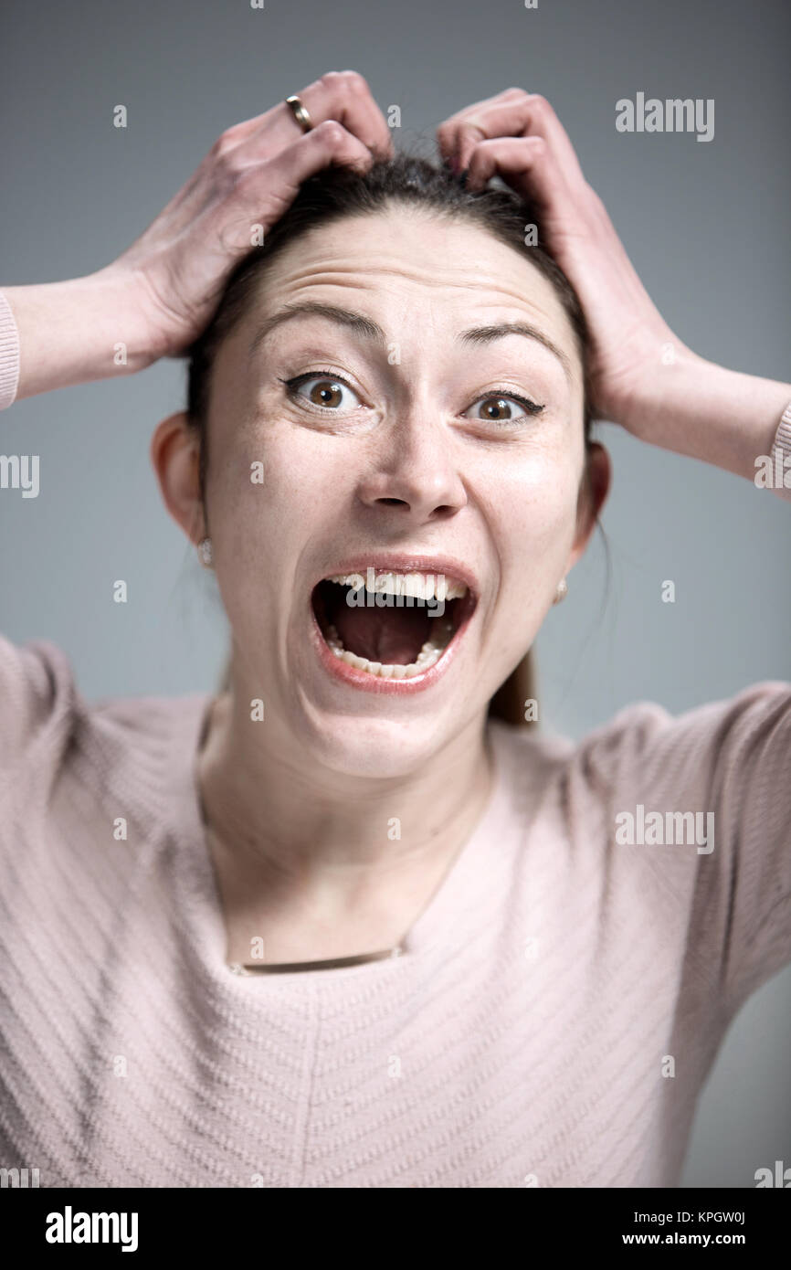 Portrait of young woman with shocked facial expression Stock Photo - Alamy