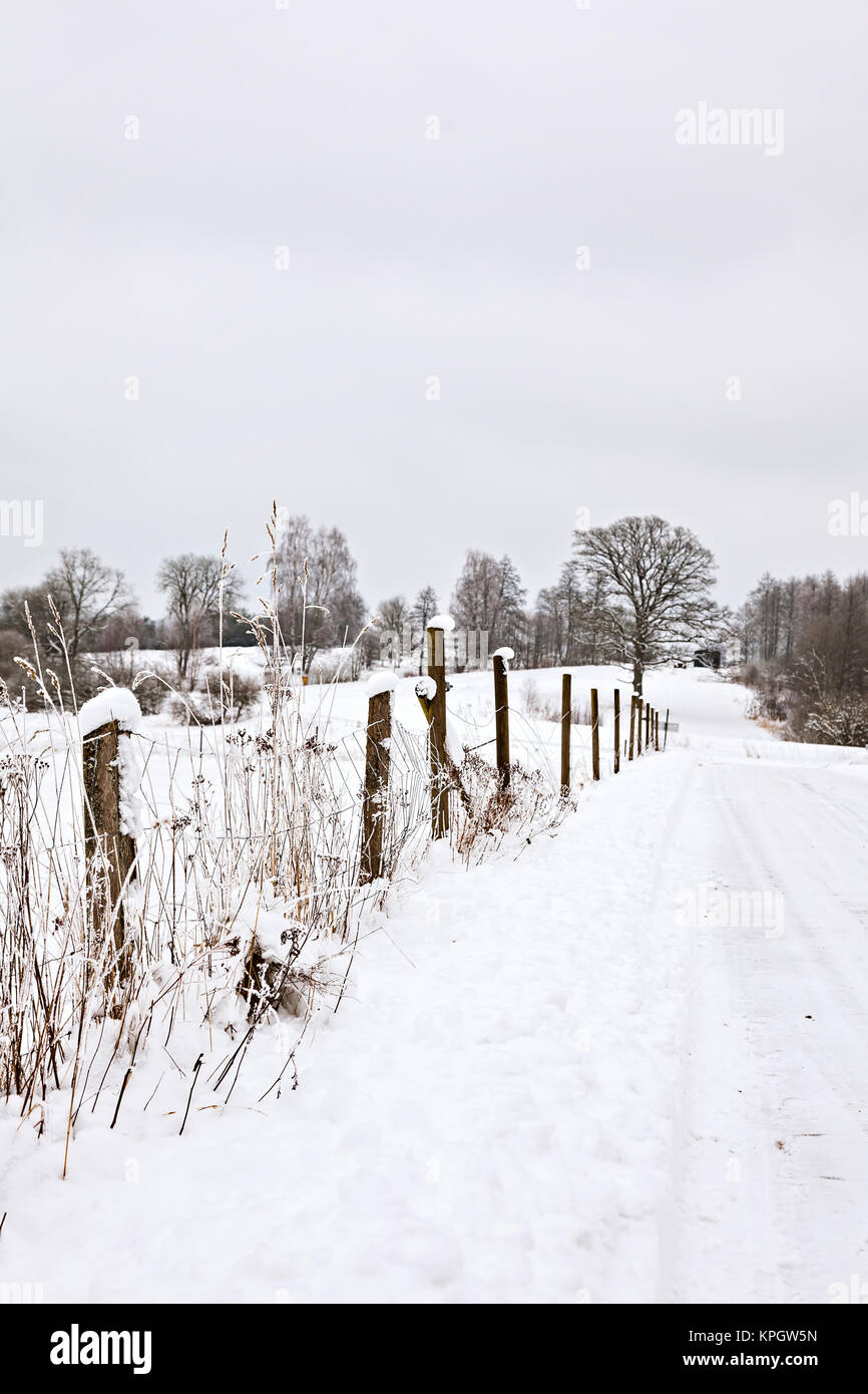 Snowy rural landscape with wooden fence Stock Photo - Alamy