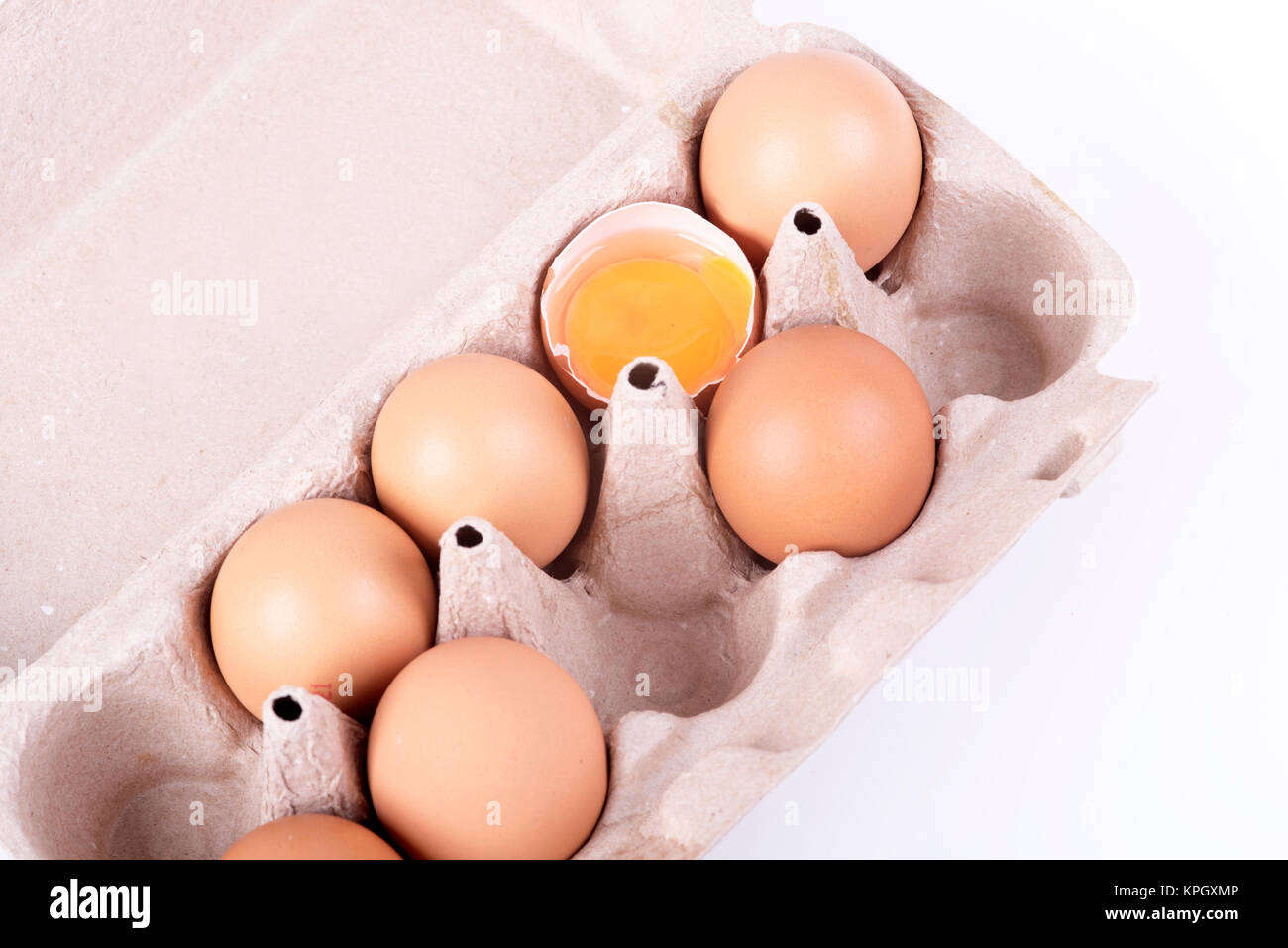broken egg in a container with egg yolk Stock Photo - Alamy