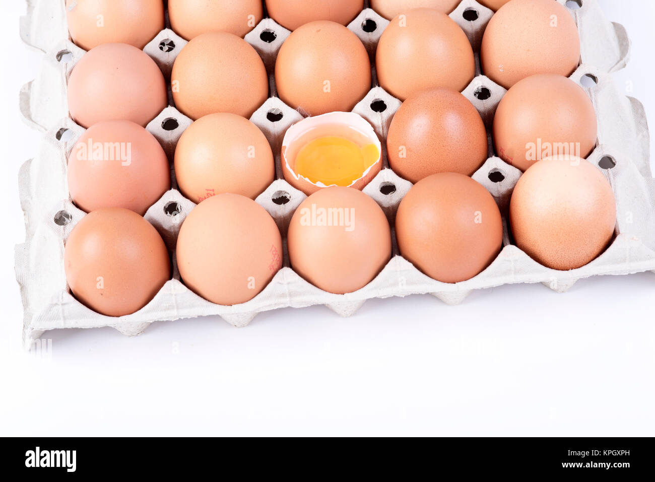 broken egg in a container with egg yolk Stock Photo - Alamy
