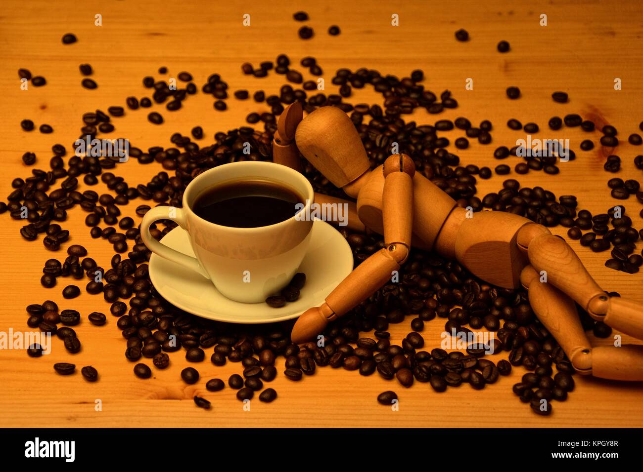Cup of coffee with wooden figure Stock Photo - Alamy