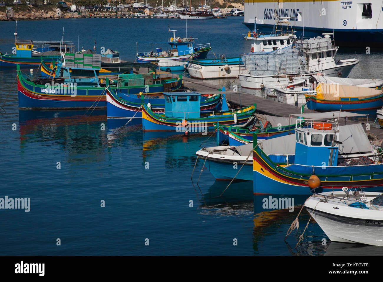 Malta, Gozo Island, Mgarr, harbor view with luzzu traditional fishing ...