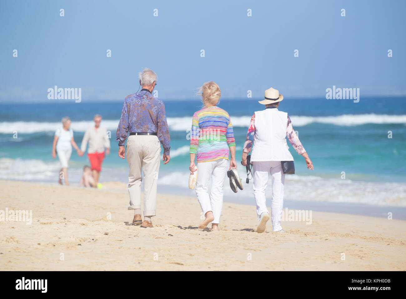 Active seniors enjoying beach walk Stock Photo - Alamy