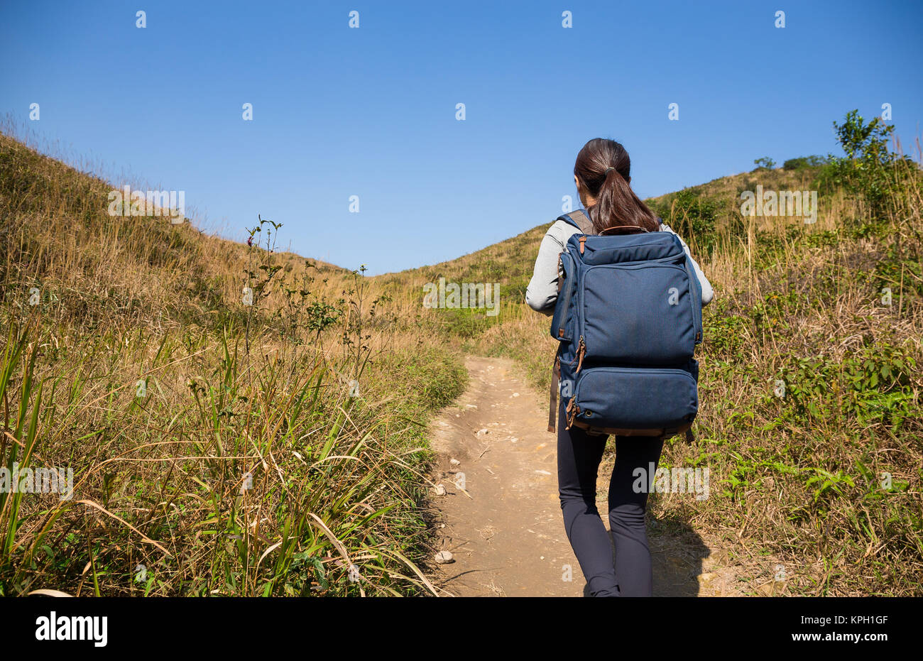Back view of woman go hiking Stock Photo - Alamy