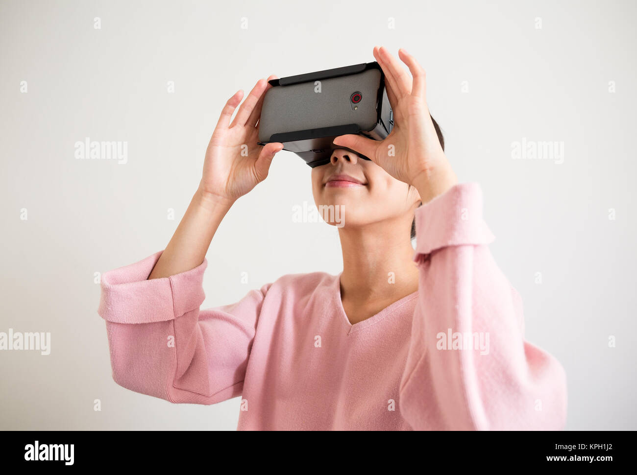 Girl uses head-mounted display Stock Photo - Alamy