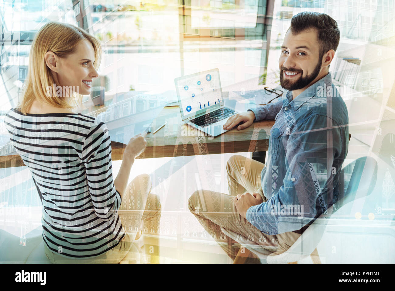 Joyful pleasant colleagues working and smiling Stock Photo - Alamy