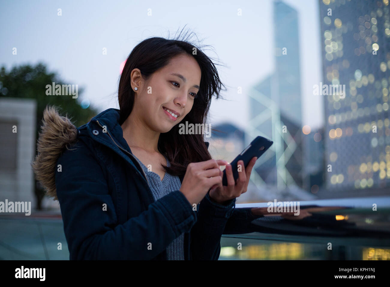 Asian girl using mobile phone at night Stock Photo - Alamy