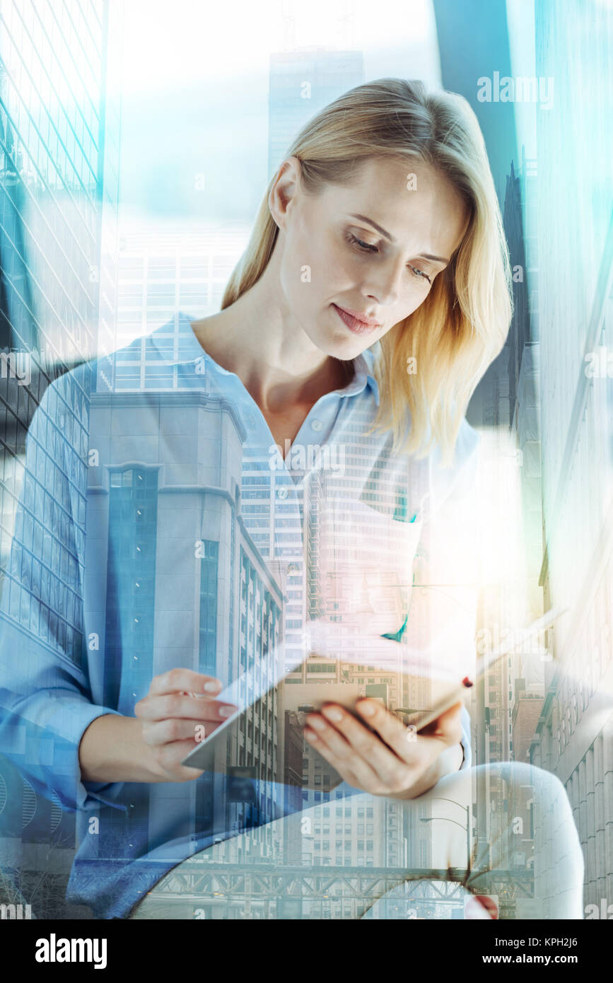 Serious deep lady sitting and reading her notebook Stock Photo - Alamy