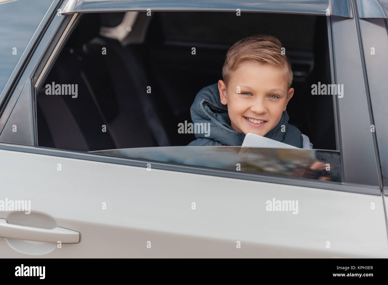 boy with digital tablet in car Stock Photo - Alamy