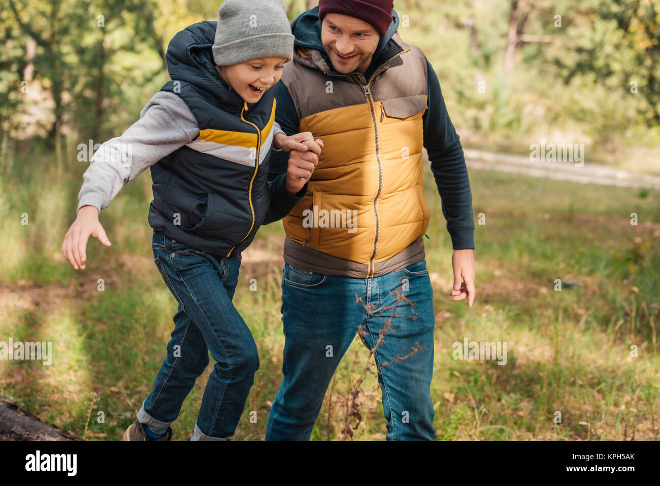 father and son walking in forest Stock Photo - Alamy
