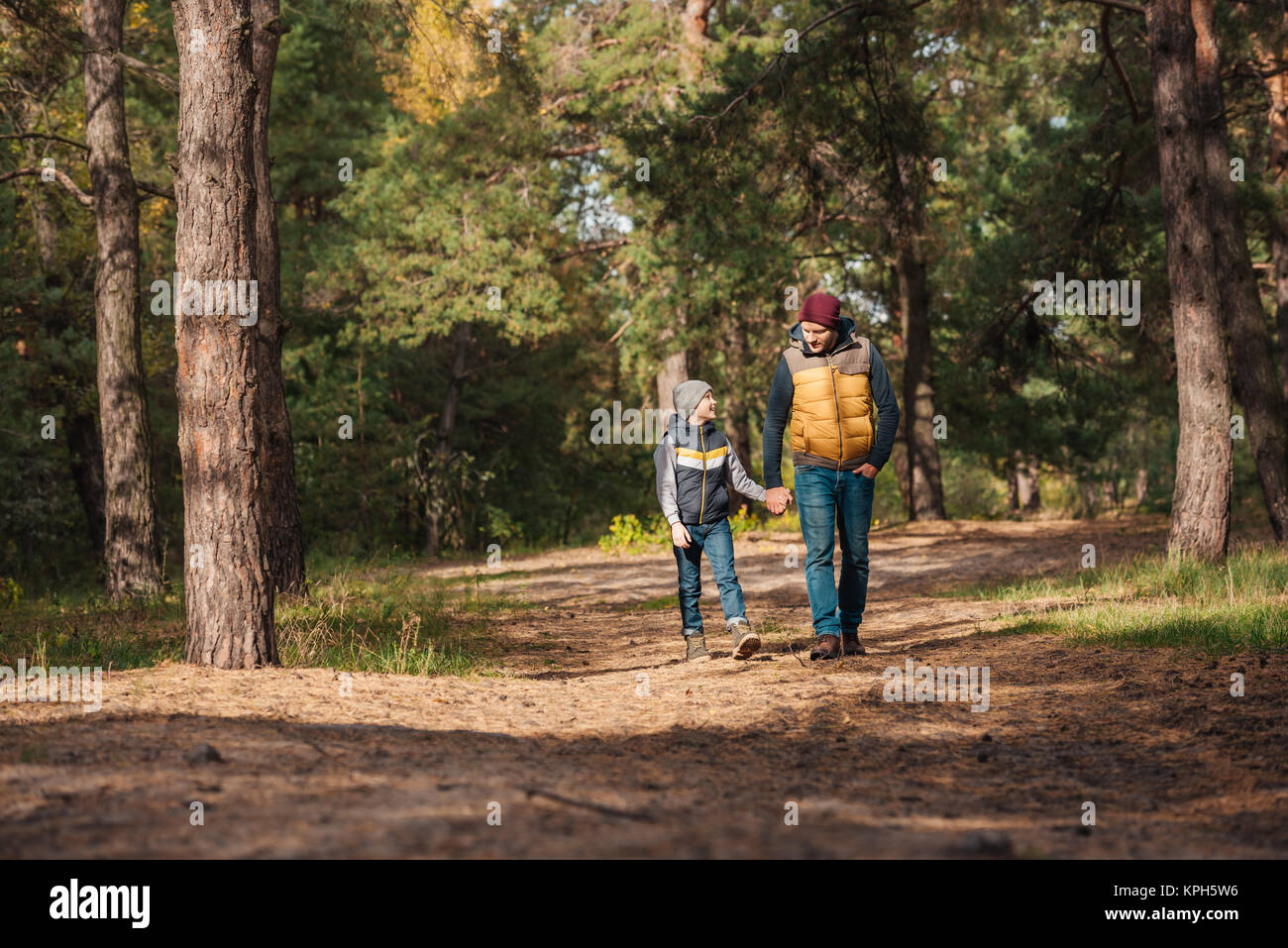 father and son walking in forest Stock Photo - Alamy