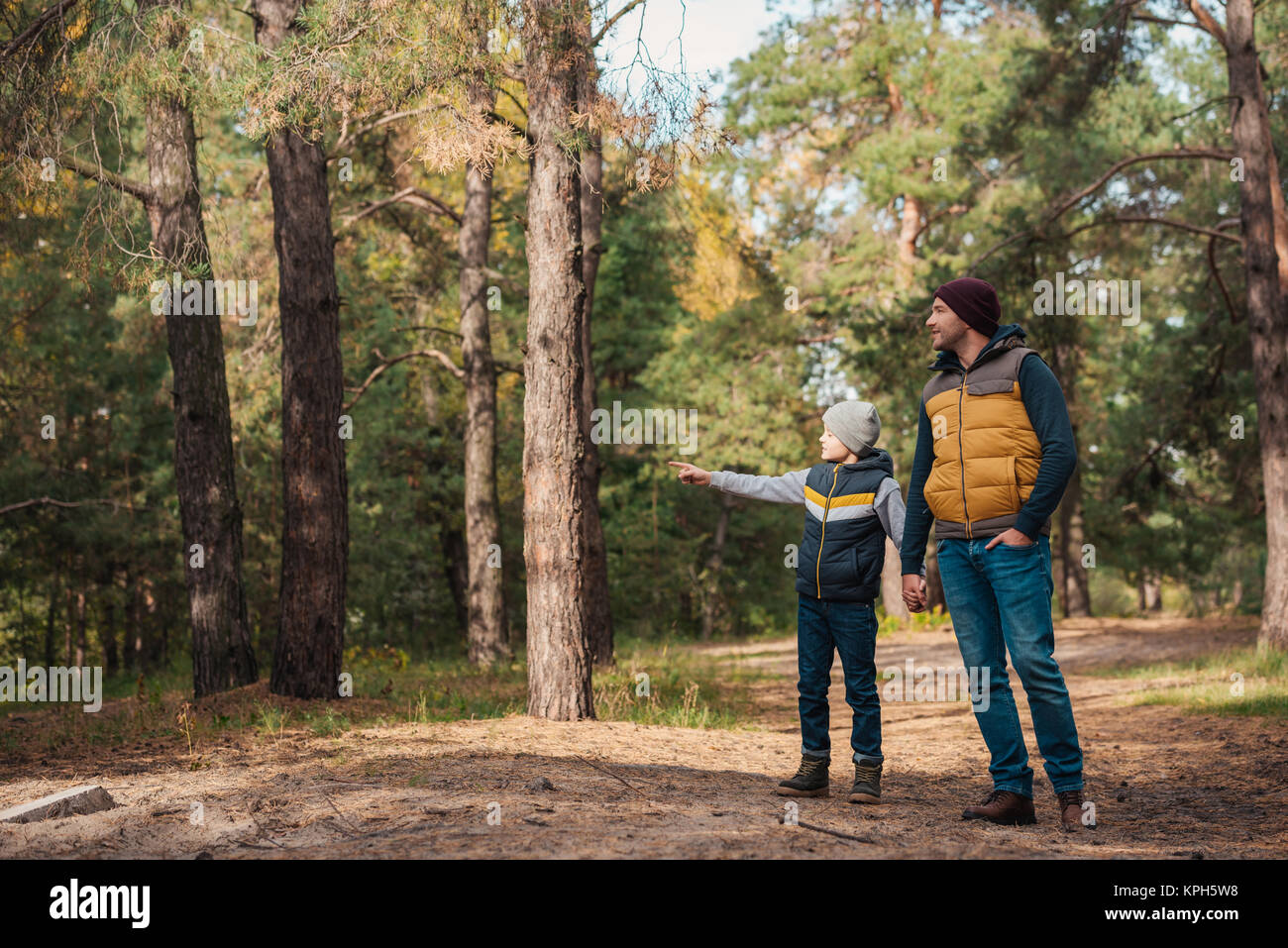 father and son walking in forest Stock Photo - Alamy