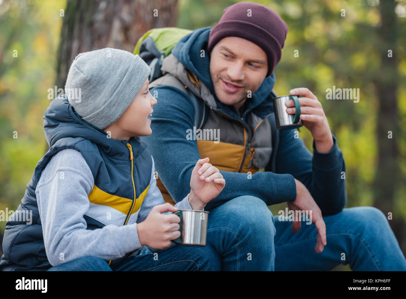 father and son drinking tea in forest Stock Photo - Alamy