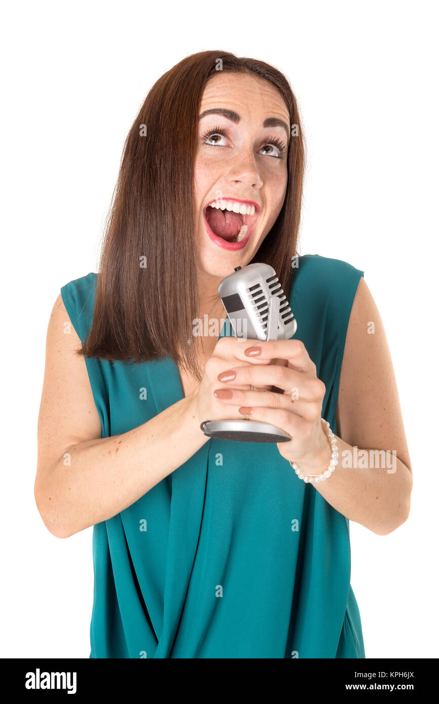 Casual young woman with a microphone isolated in a white background ...