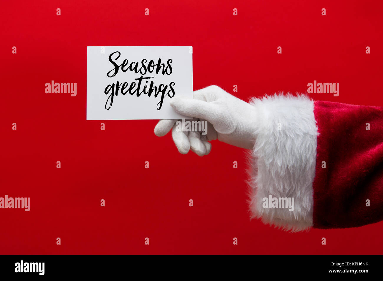 Santa Claus hand holding a Christmas sign Stock Photo - Alamy