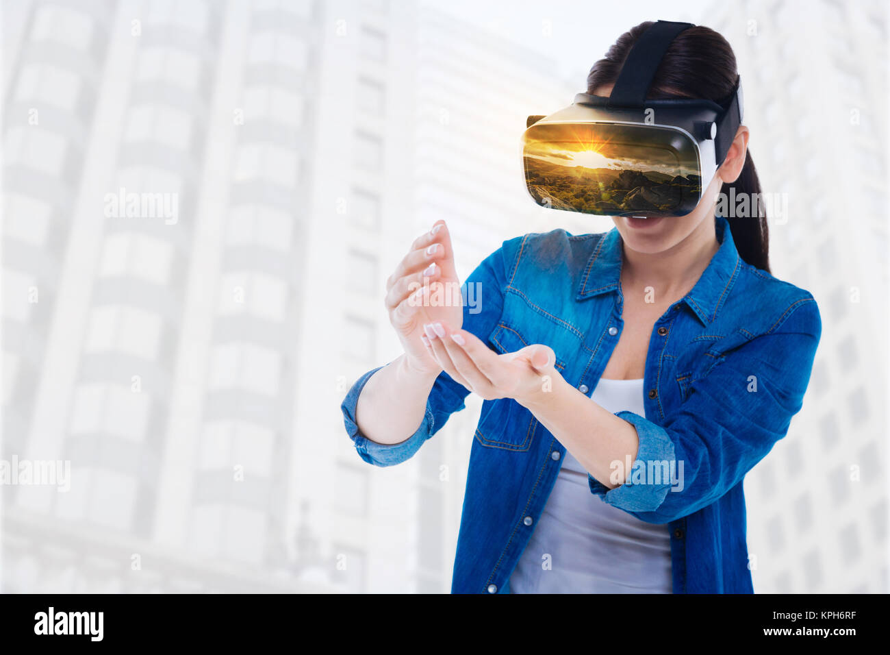 Pretty confident woman fascinated by VR Stock Photo - Alamy